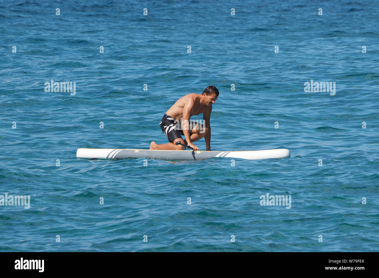 Paddle boarding man hi-res stock photography and images - Alamy