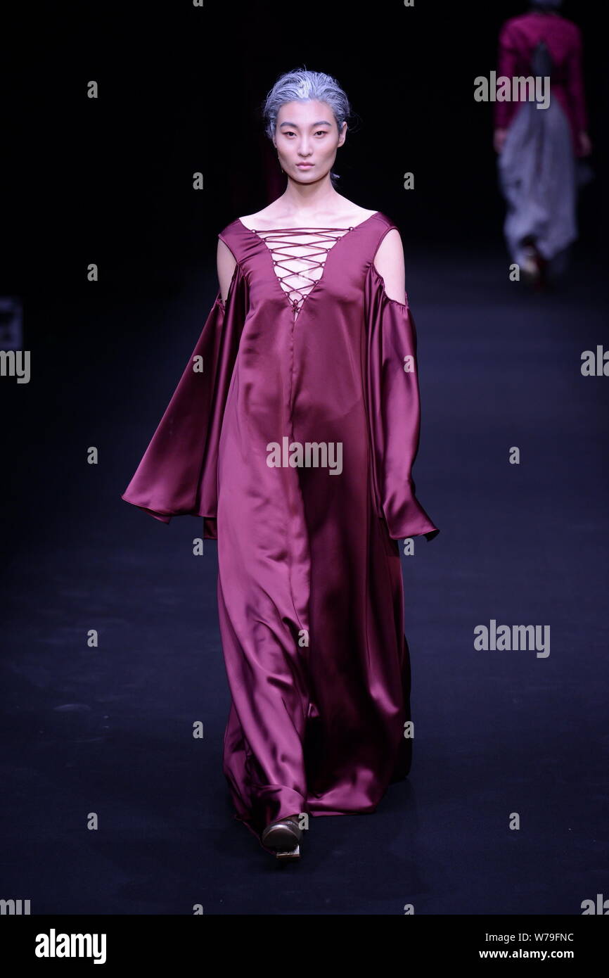 A model displays a new creation at the fashion show of Mid Time & Mija ...