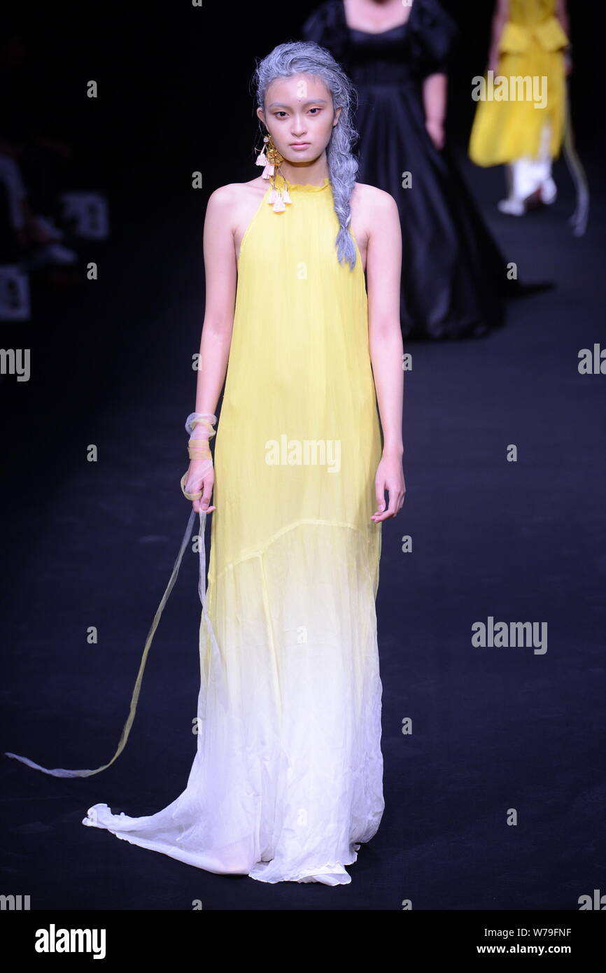 A model displays a new creation at the fashion show of Mid Time & Mija ...