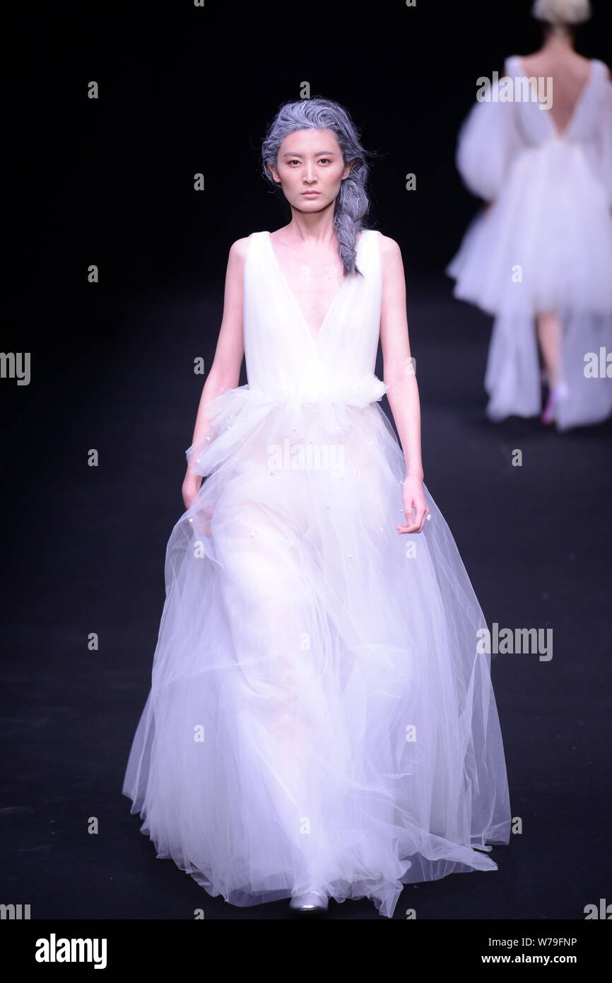 A model displays a new creation at the fashion show of Mid Time & Mija ...