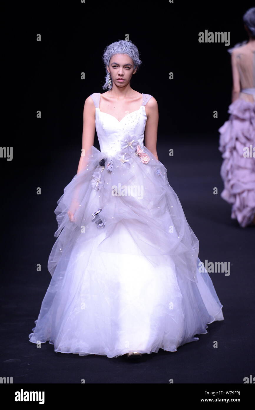 A model displays a new creation at the fashion show of Mid Time & Mija ...