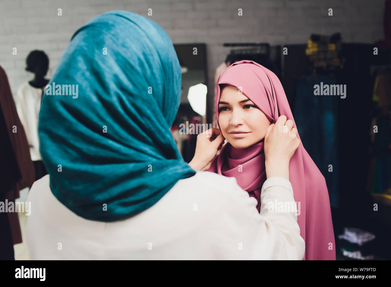 Arab woman in traditional Muslim clothes buys a new dress in an ...