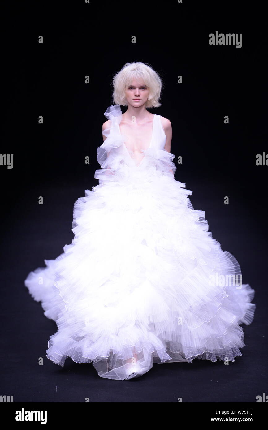 A model displays a new creation at the fashion show of Mid Time & Mija ...