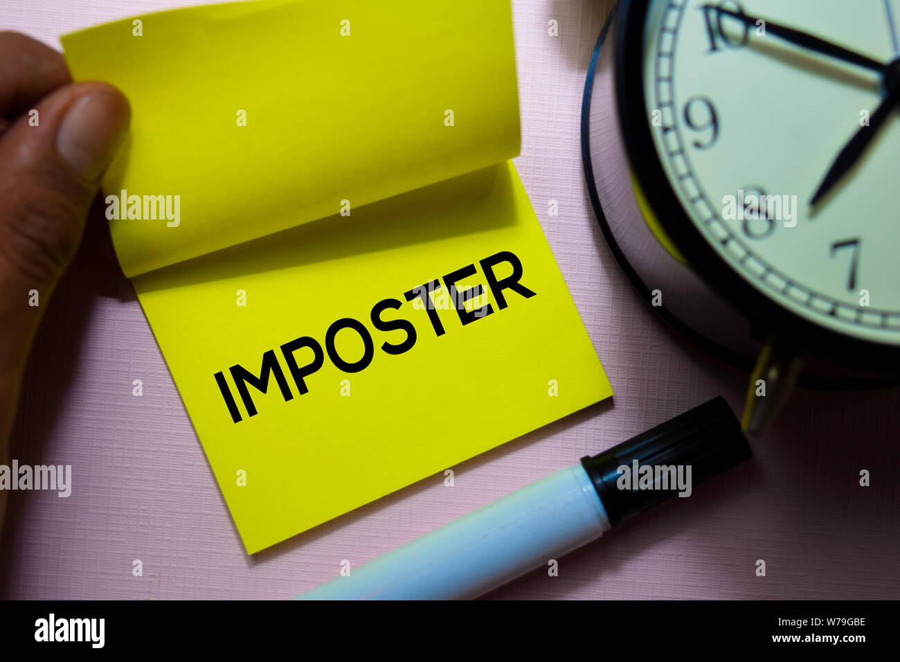 Imposter text on sticky notes isolated on office desk Stock Photo - Alamy