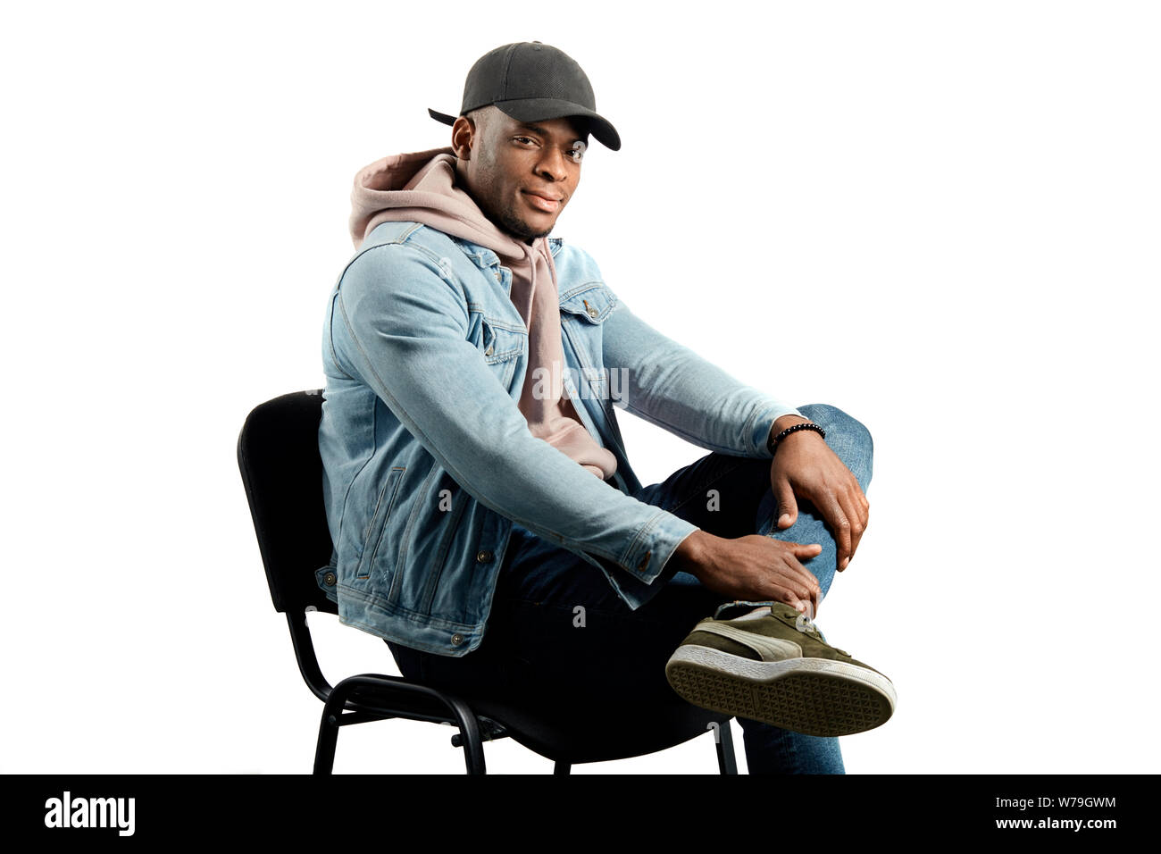 stylish male model sitting on the chair in the studio. businessman ...