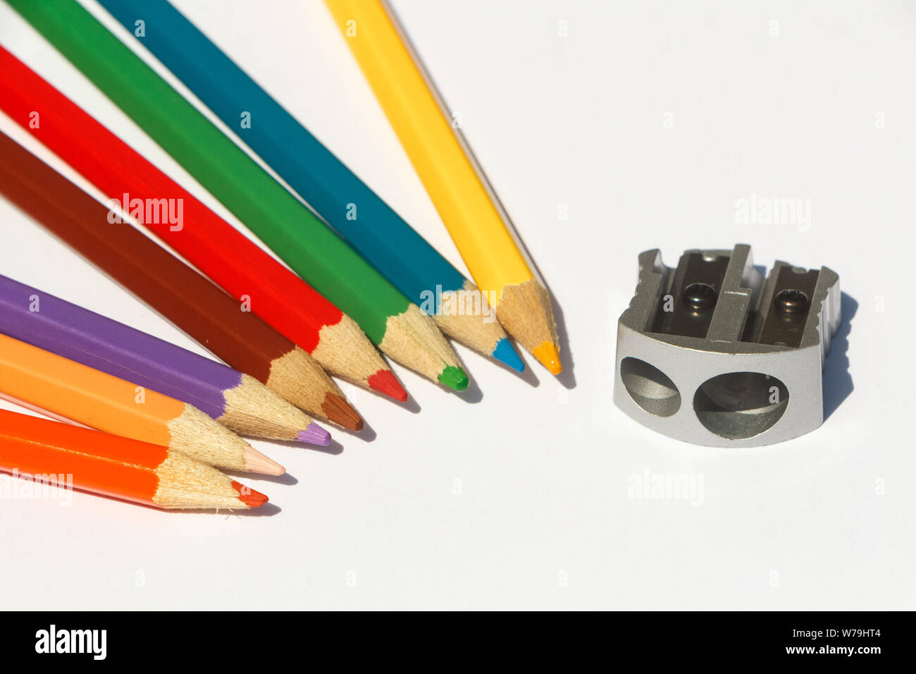 Colored pencils and sharpener on white background Stock Photo - Alamy