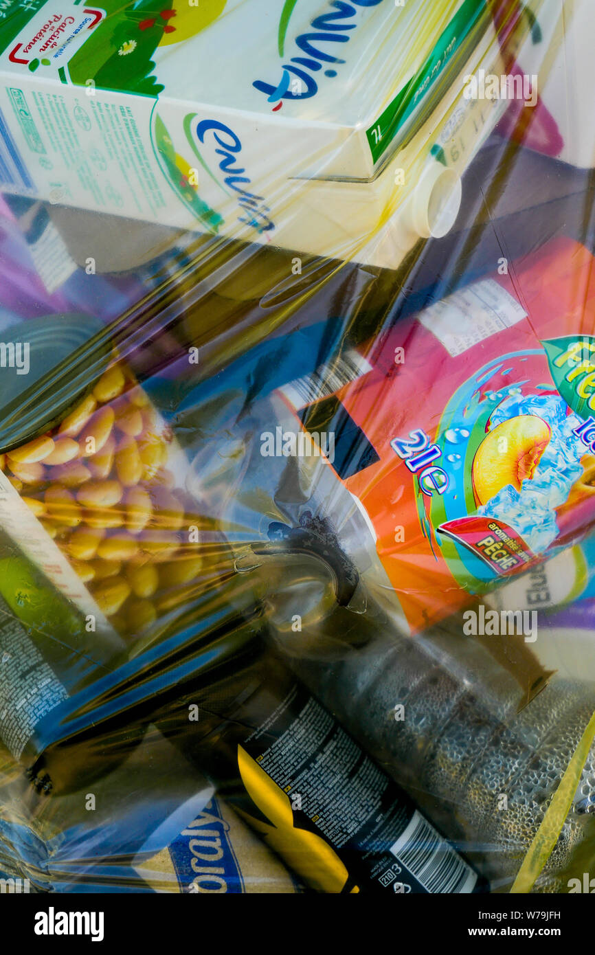 A yellow plastic bag filled with recyclable items hangs at a "Sorting ...