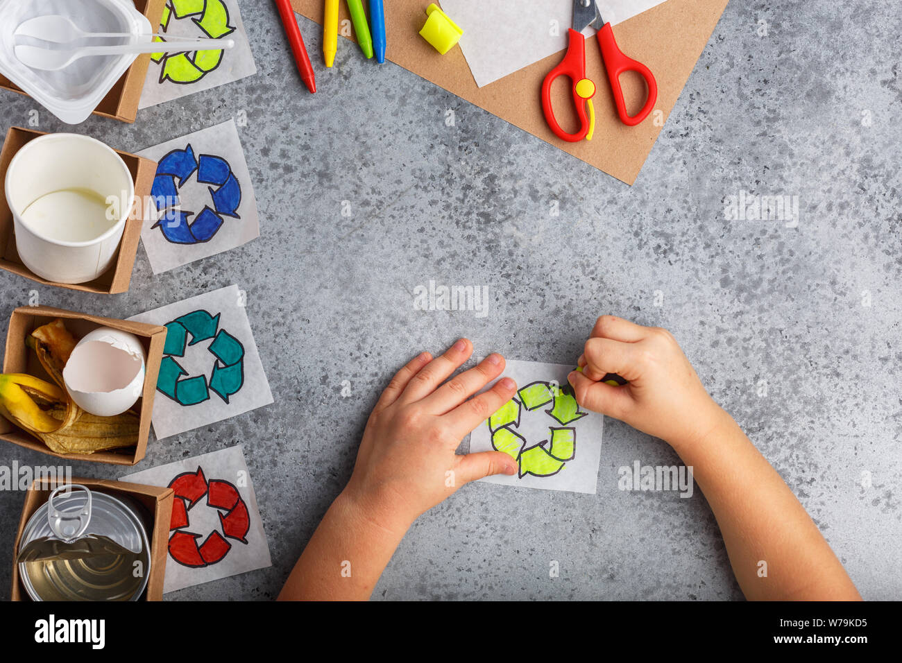 Kids hands is making recycling game kid is drawing recycle sign paper ...