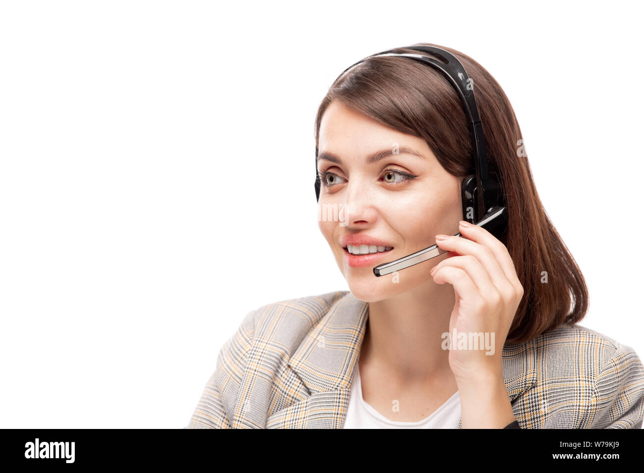 Pretty young polite manager of call center talking to one of clients ...