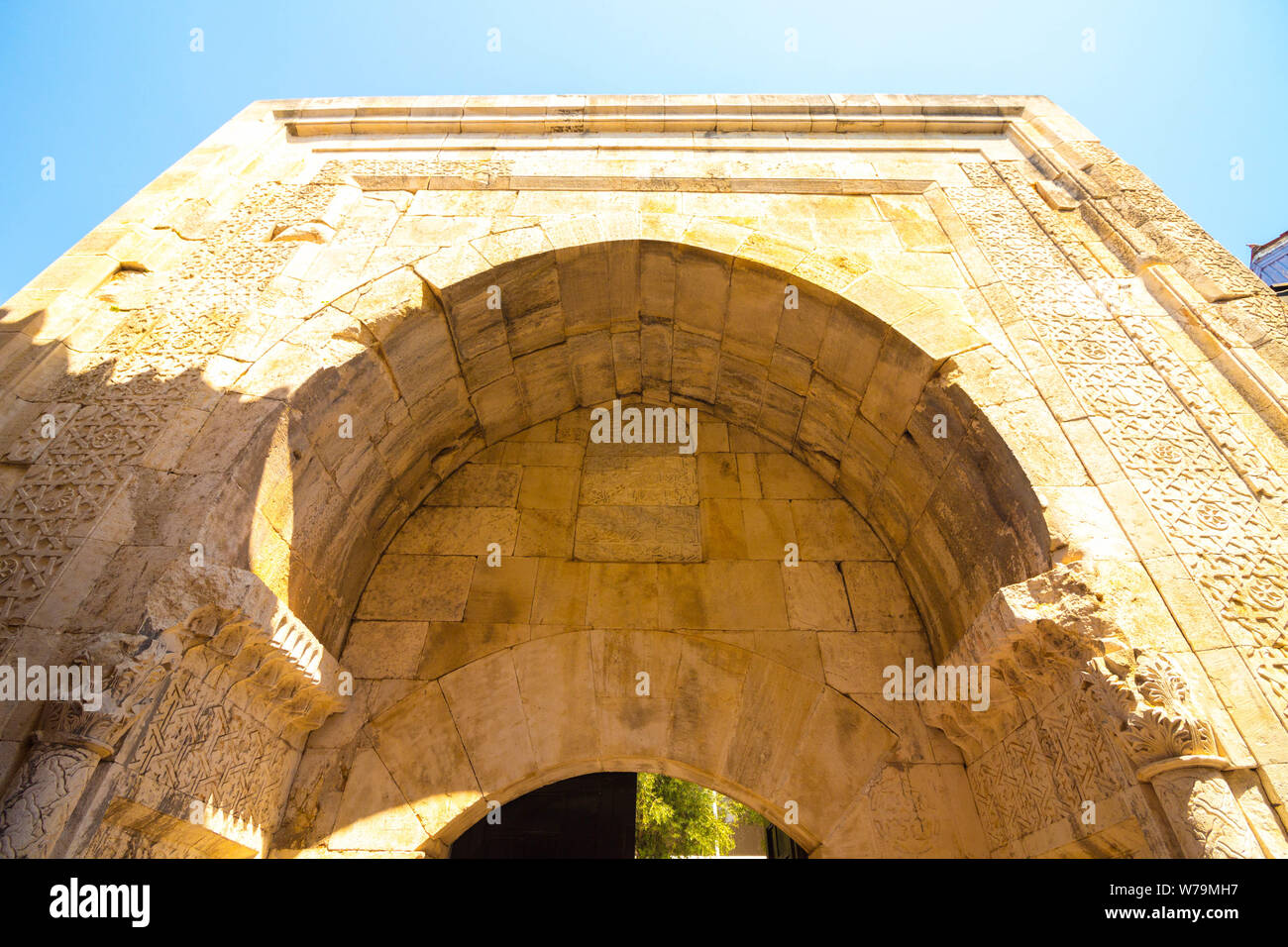 The high arch is built of stone blocks. The arch serves as a passage to ...