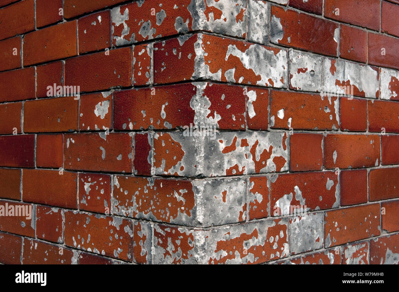 A Close Up Of The Corner Of A Building Faced In Chipped Ceramic Bricks ...