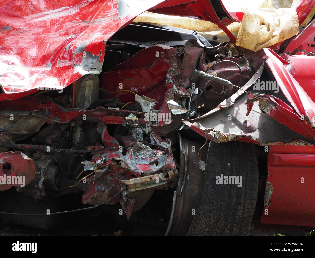 Closeup view of a heavily-wrecked red car Stock Photo - Alamy