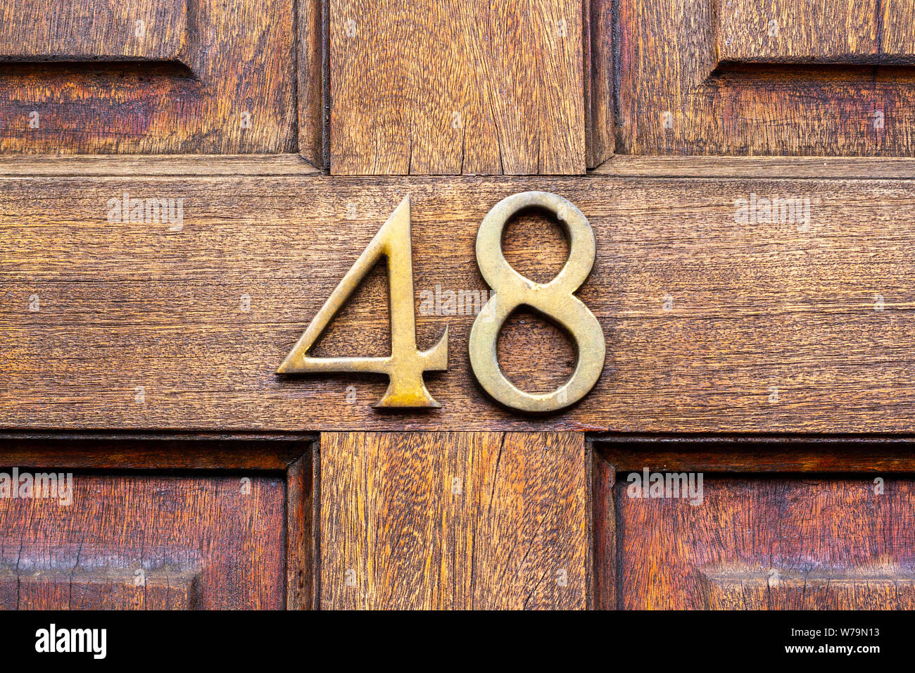 House number 48 on a natural wooden front door Stock Photo - Alamy