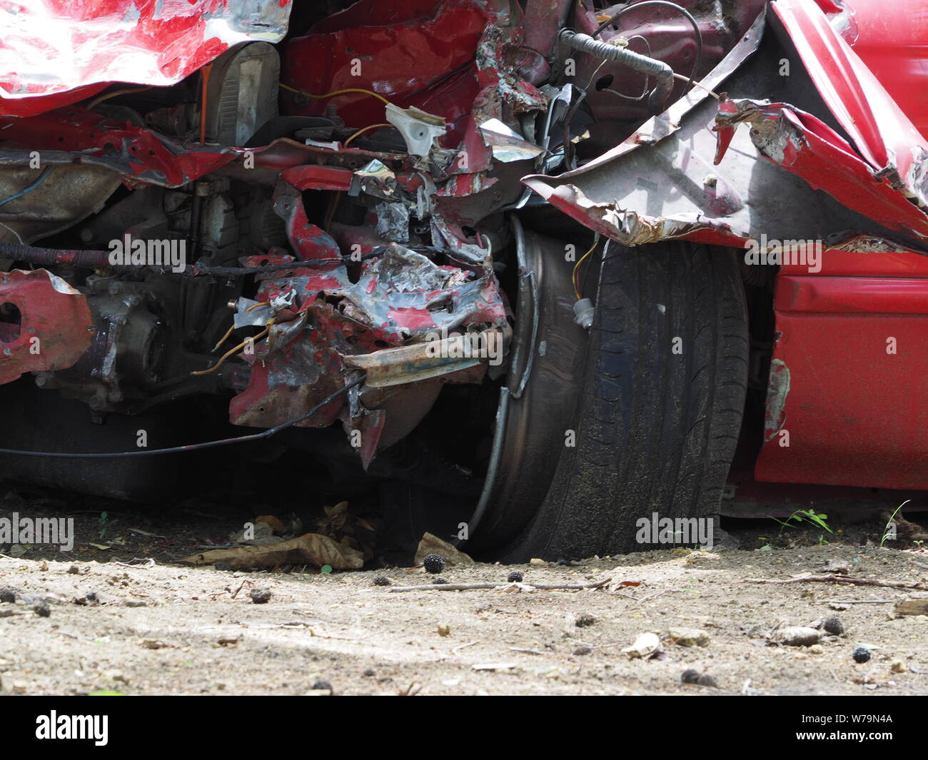 Closeup view of a heavily-wrecked red car Stock Photo - Alamy