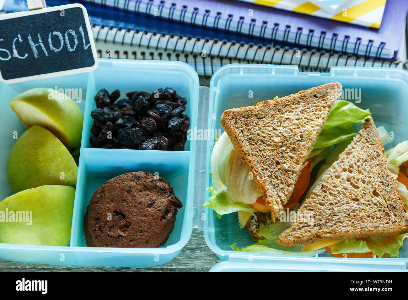 School blue lunch box with homemade sandwich, green apple, cookies ...