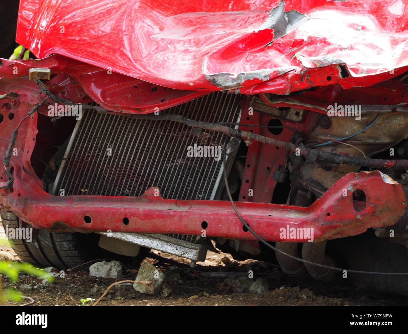 Closeup view of a heavily-wrecked red car Stock Photo - Alamy