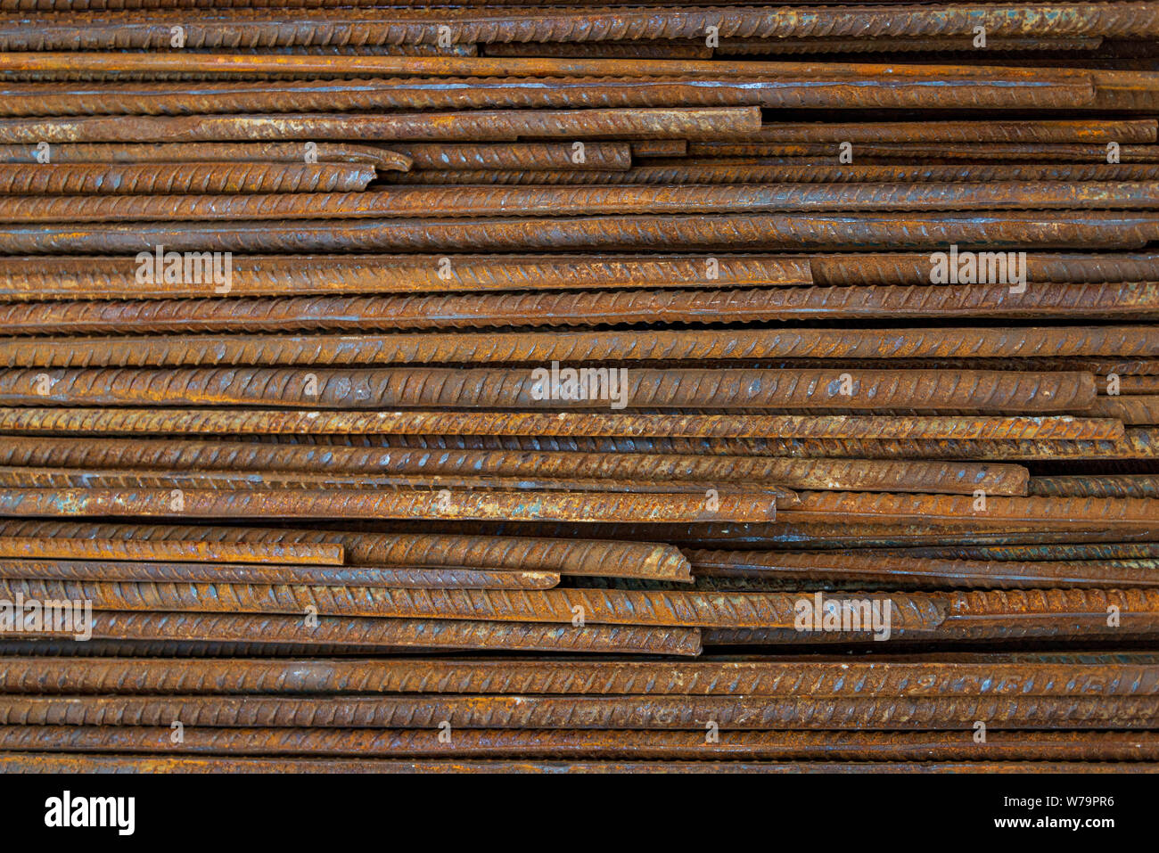 Top horizontal close up view stack of straight old rusty high yield ...