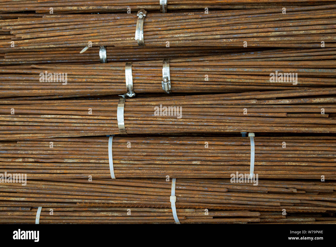 Top horizontal view close up stack of straight old rusty high yield ...