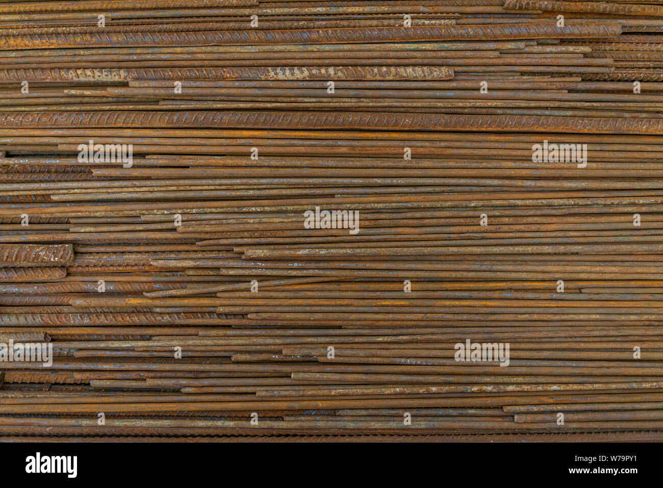 Top horizontal close up view stack of straight old rusty high yield ...