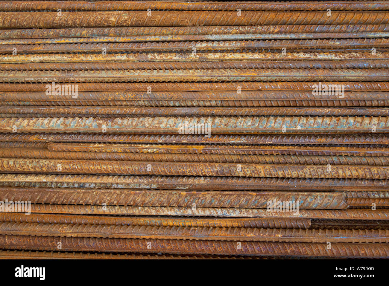 Top horizontal close up view stack of straight old rusty high yield ...