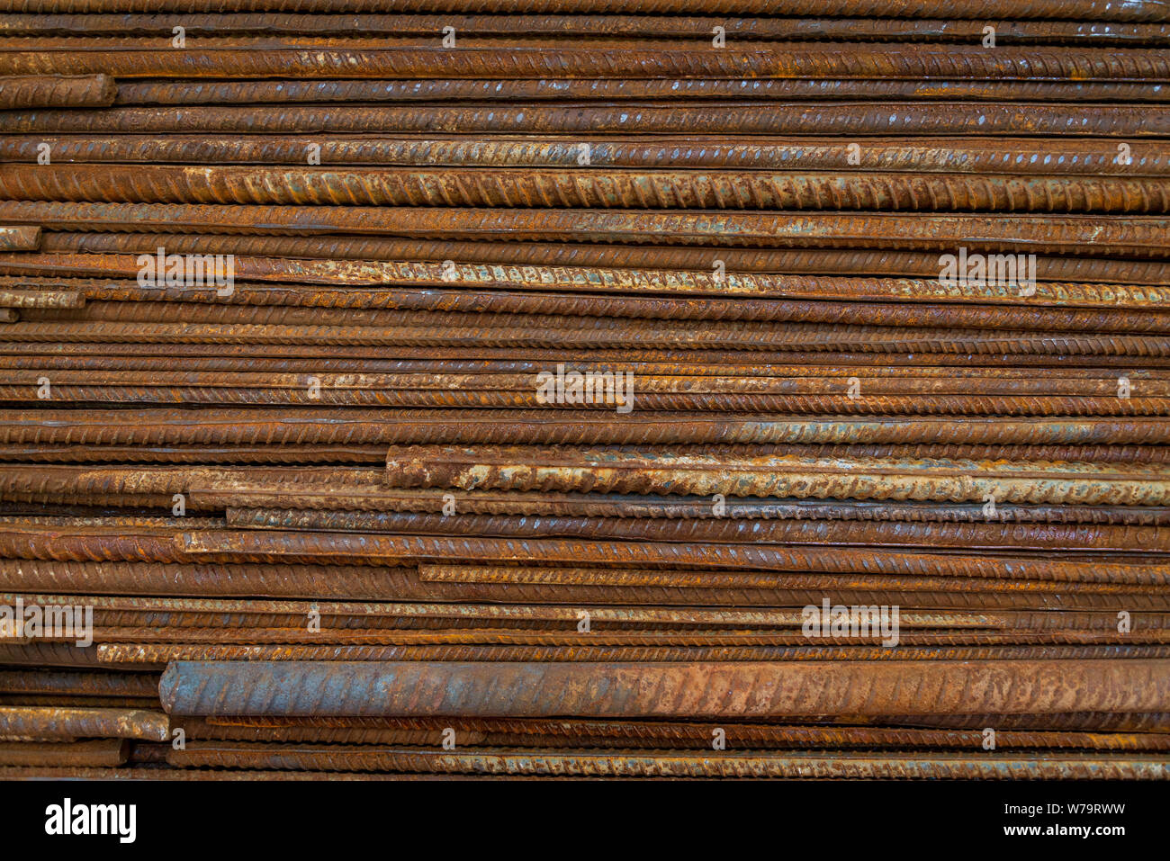 Top horizontal close up view stack of straight old rusty high yield ...