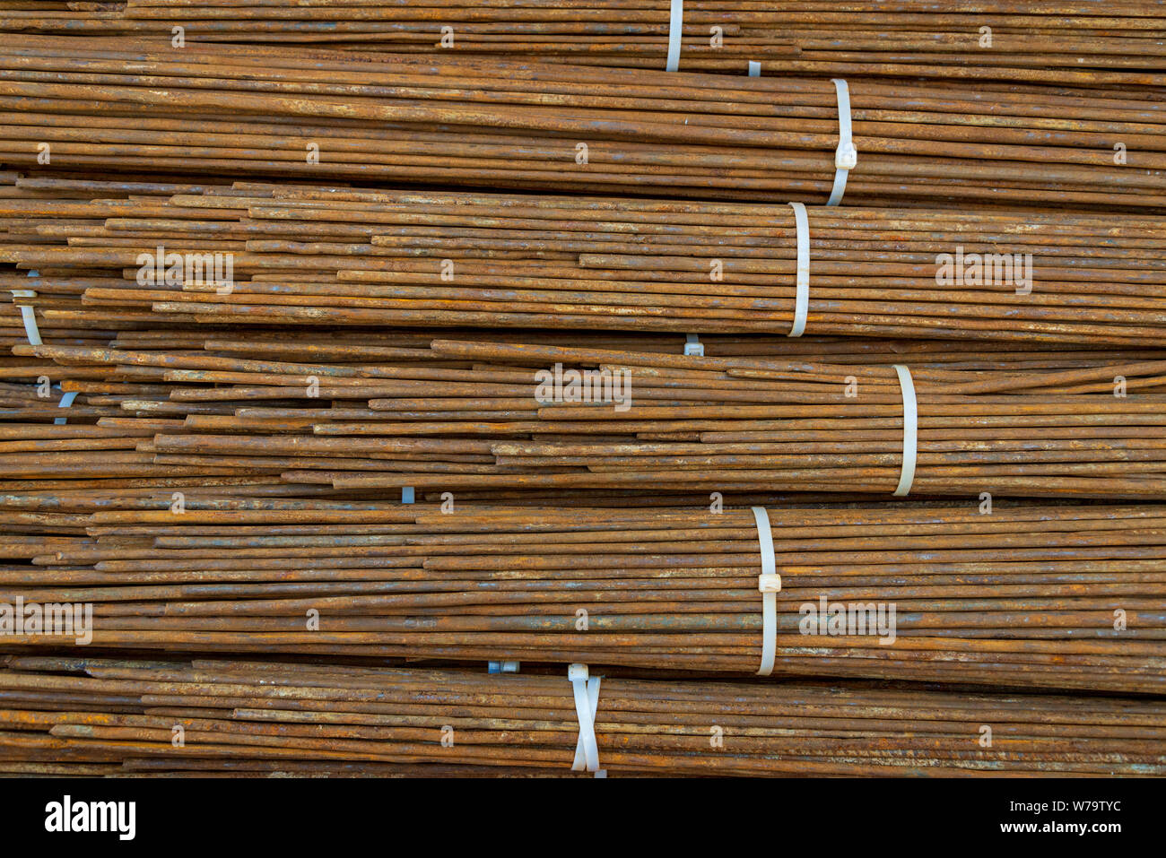 Top horizontal view close up stack of straight old rusty high yield ...