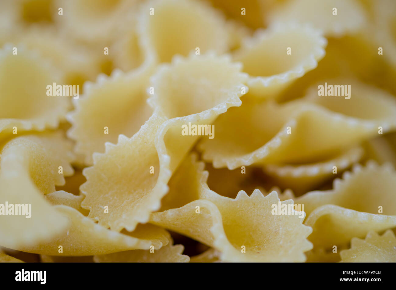 Raw farfalle pasta background,close up, top view Stock Photo - Alamy