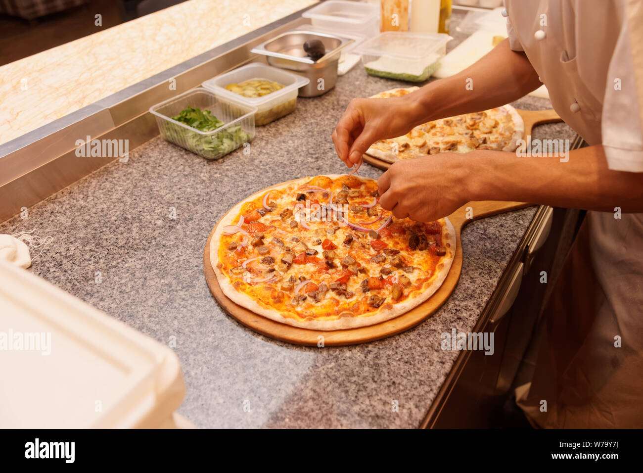 Chef is serving pizza, professional kitchen of pizzeria Stock Photo - Alamy