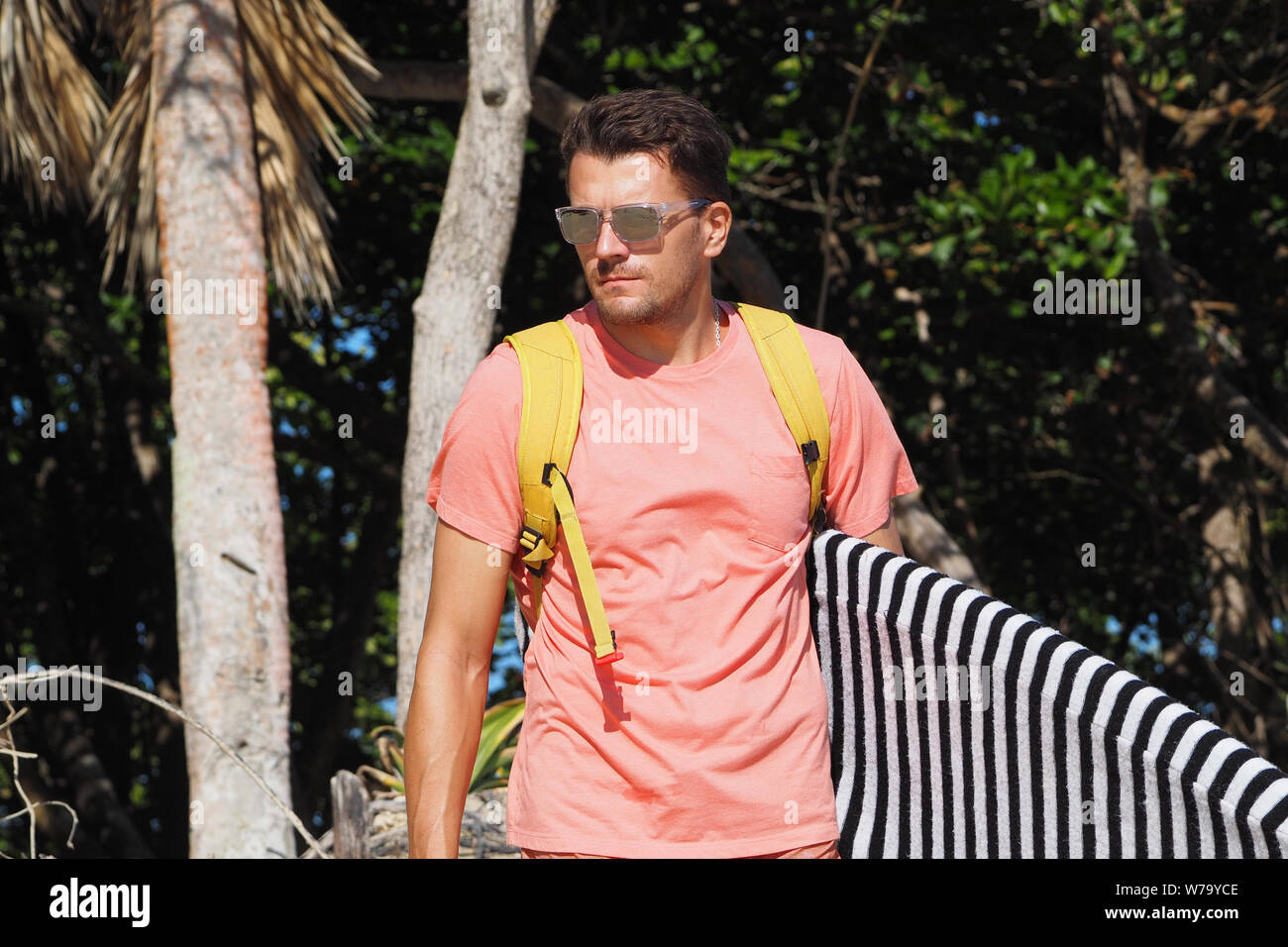 Male surfer checks the waves on the beach Stock Photo - Alamy