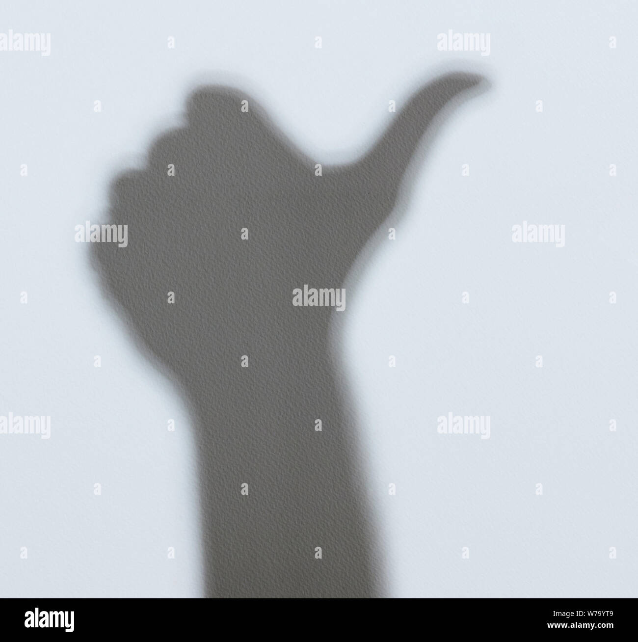 Shadow of hand with thumb up on white wall background Stock Photo - Alamy