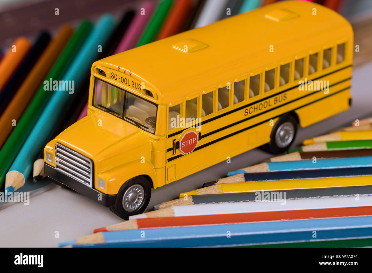 Toy school bus with color wooden pencils. Close up Stock Photo - Alamy