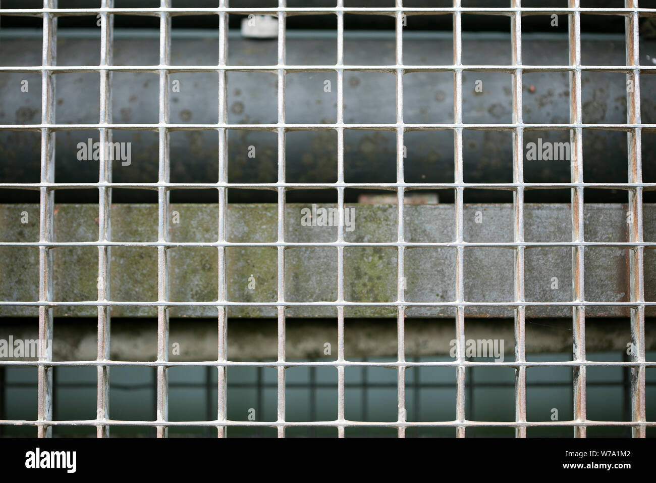 Jail metallic window with small quadrants diagonal strait lines macro ...