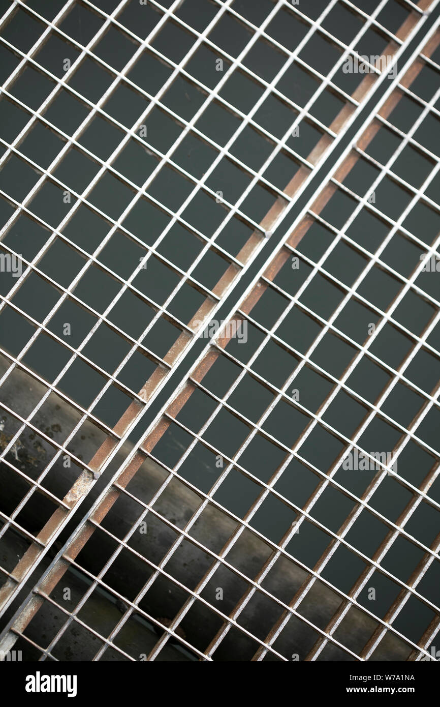 Jail metallic window with small quadrants diagonal strait lines macro ...