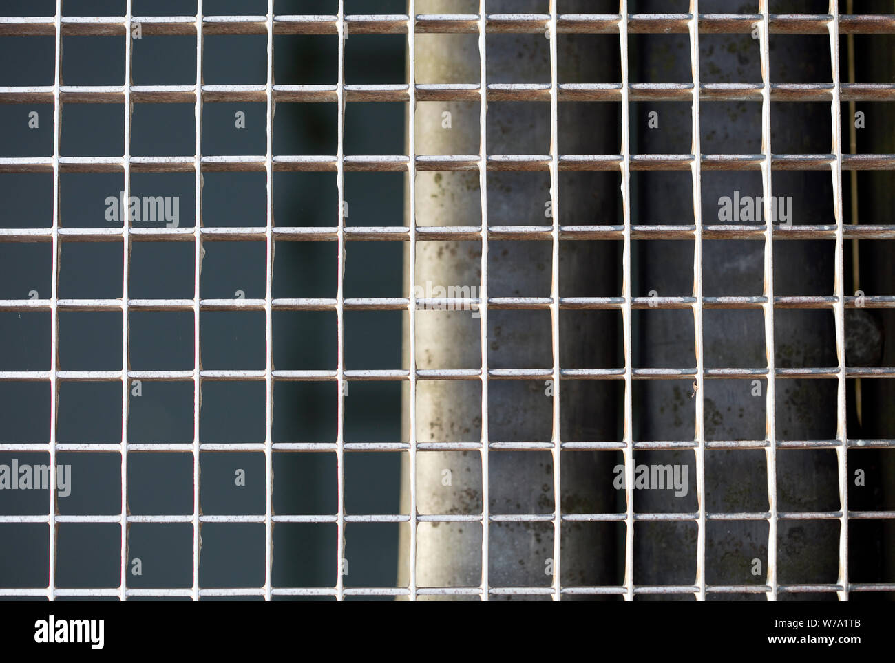 Jail metallic window with small quadrants diagonal strait lines macro ...