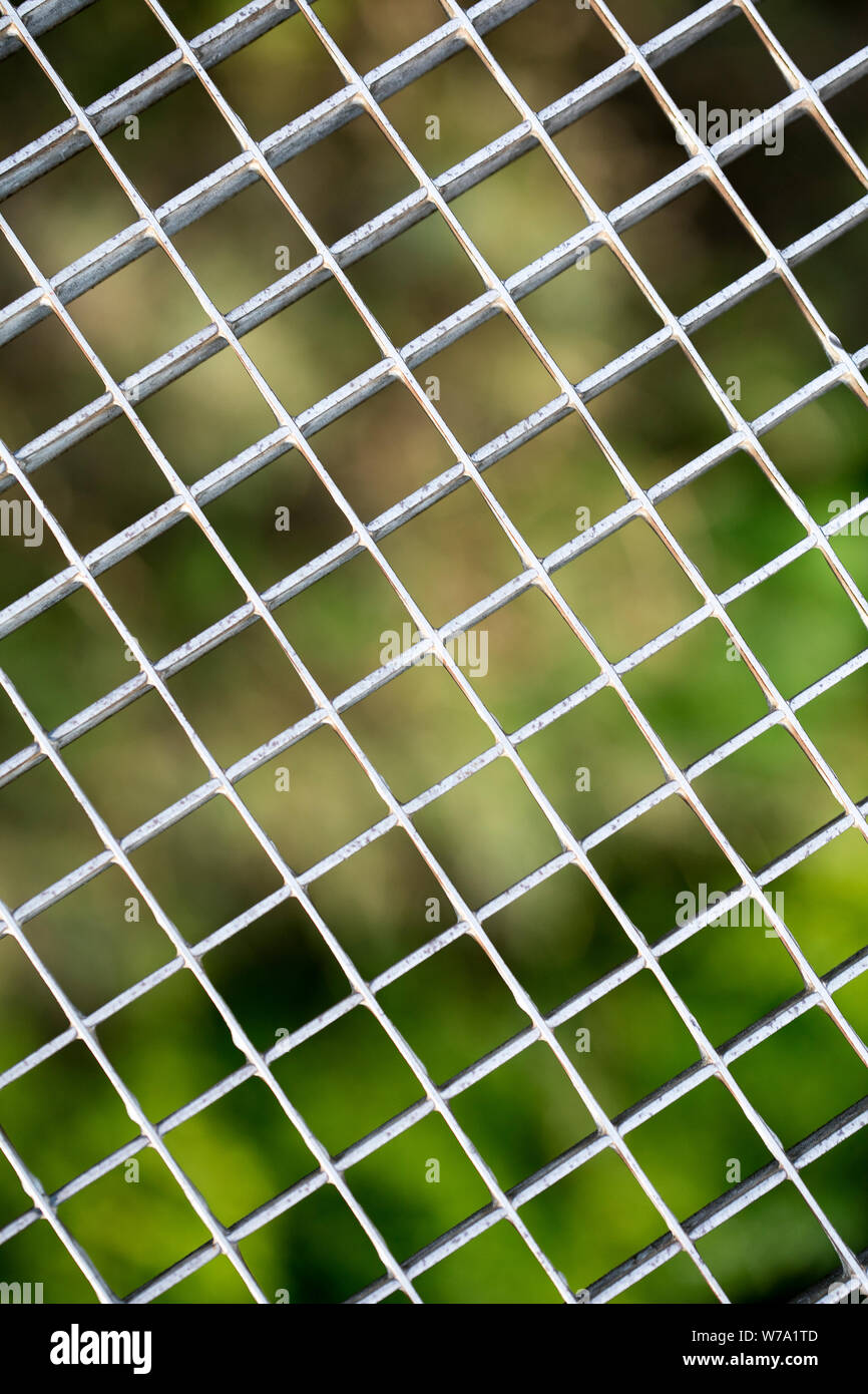 Jail metallic window with small quadrants diagonal strait lines macro ...