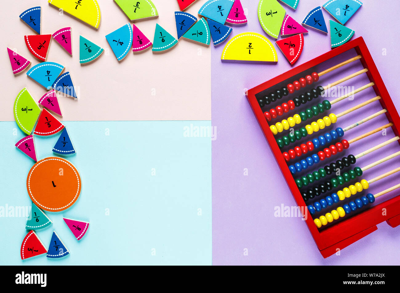 Colorful math fractions and wooden abacus on the pink blue violet ...