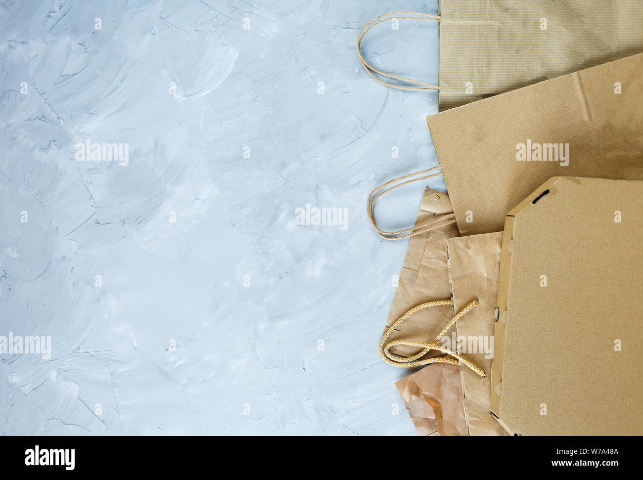 Flat lay of paper wastes as bags, boxes ready for recycling on gray ...