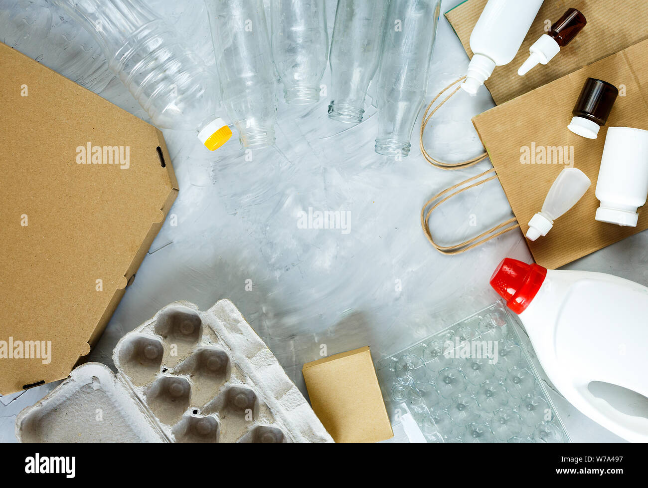 Flat lay of different wastes ready for recycling in white basket ...