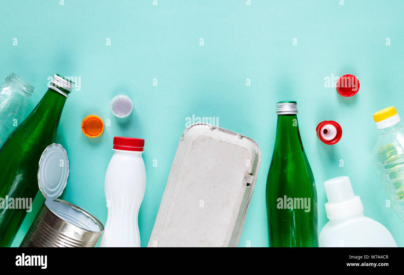Flat lay of different wastes ready for recycling on green background ...