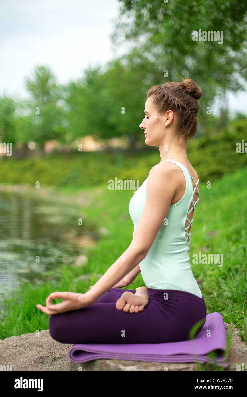 Yoga woman practicing yoga lesson, breathing, meditation, doing ...