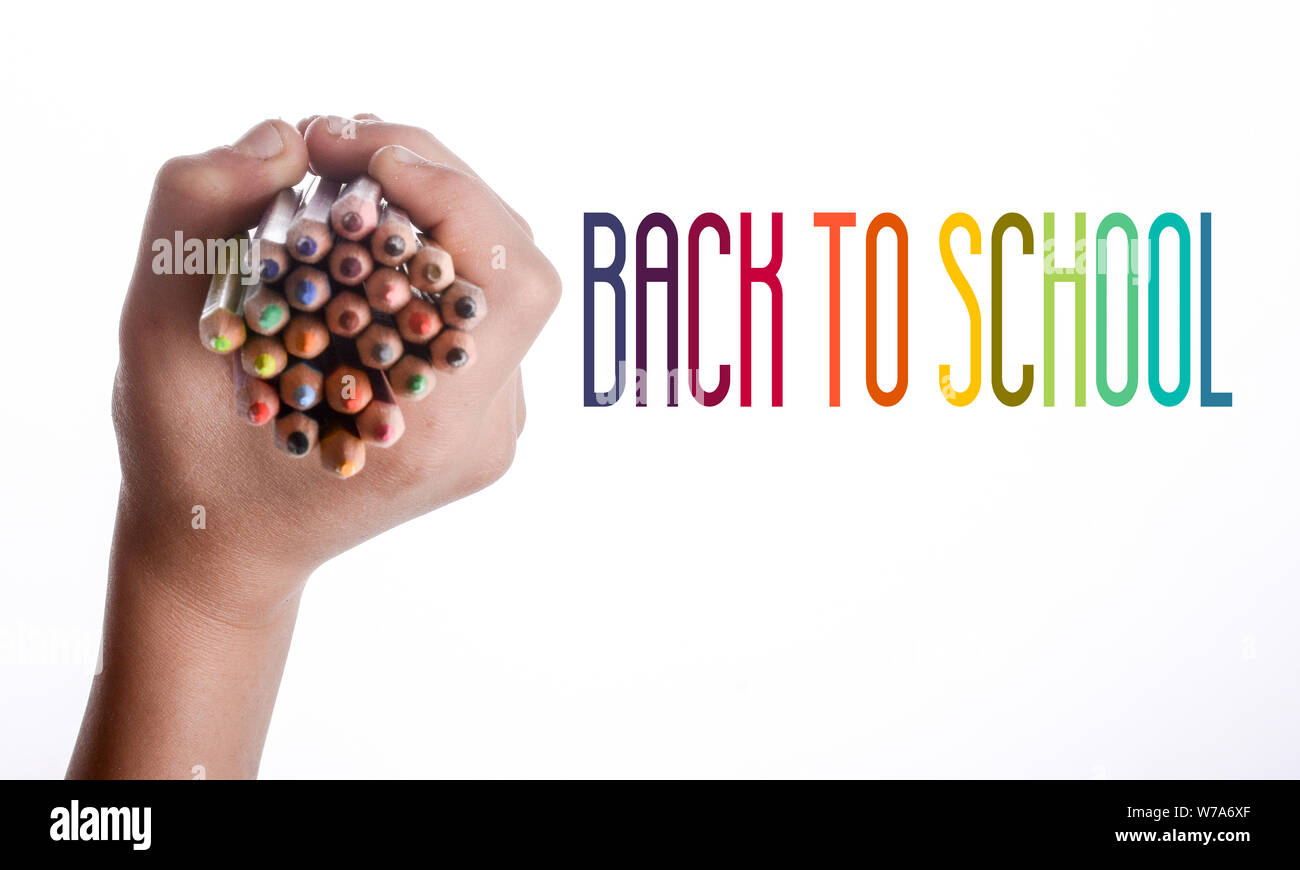 child holding colour pencils in hand on white background Stock Photo ...