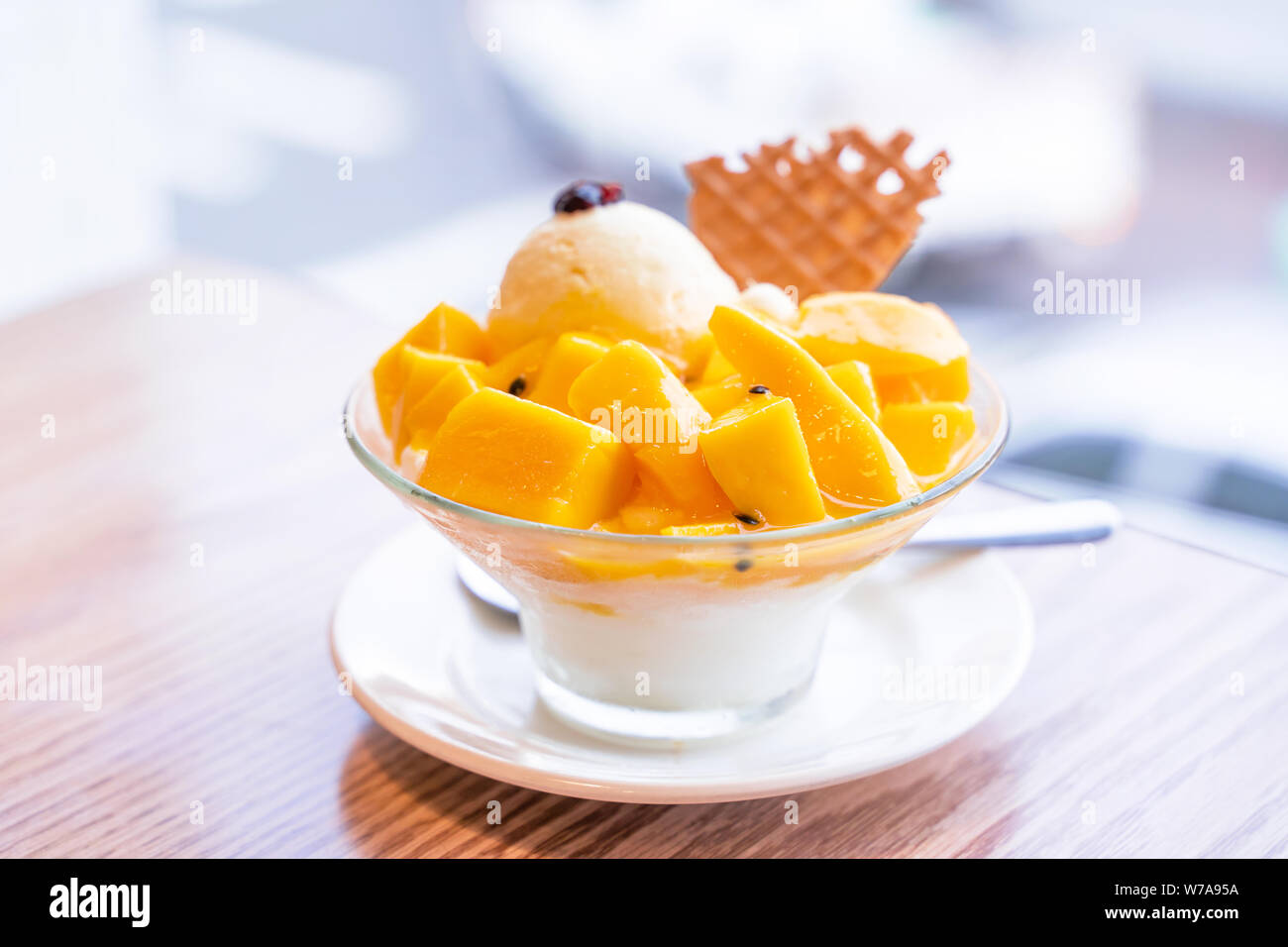 Fresh mango shaved ice with a scoop of ice cream and juice sauce in ...