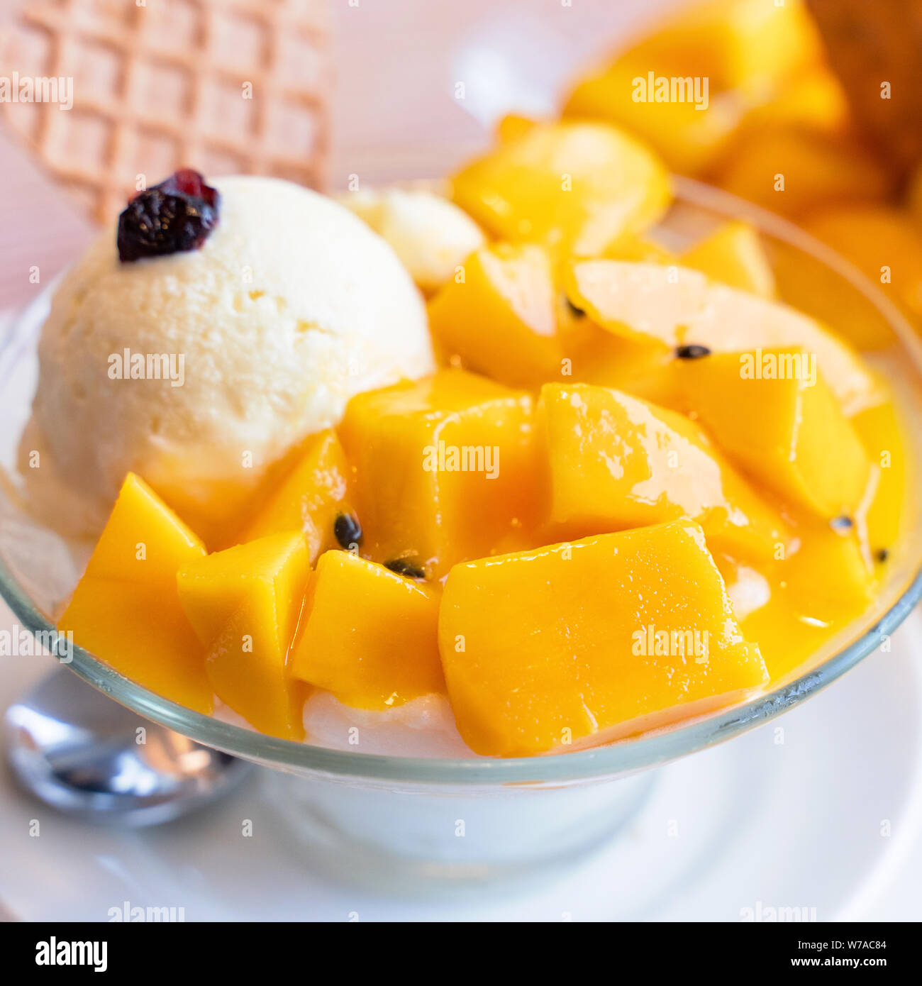 Fresh mango shaved ice with a scoop of ice cream and juice sauce in ...