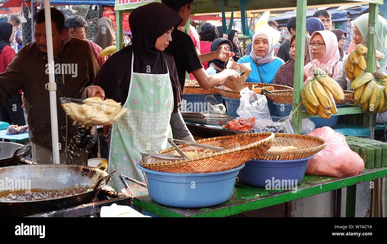 Jakarta, Indonesia - August 2019 : A muslim woman are frying bananas ...