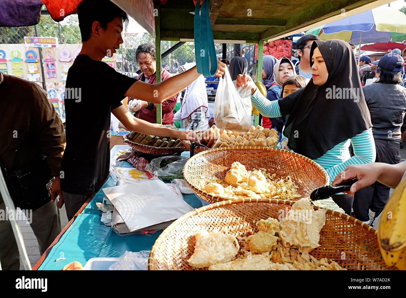 A view of seller and buyer in a street food booth Stock Photo - Alamy