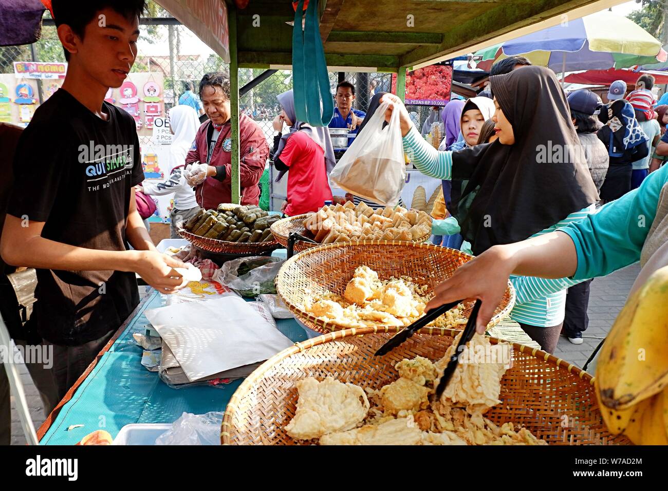 A view of seller and buyer in a street food booth Stock Photo - Alamy