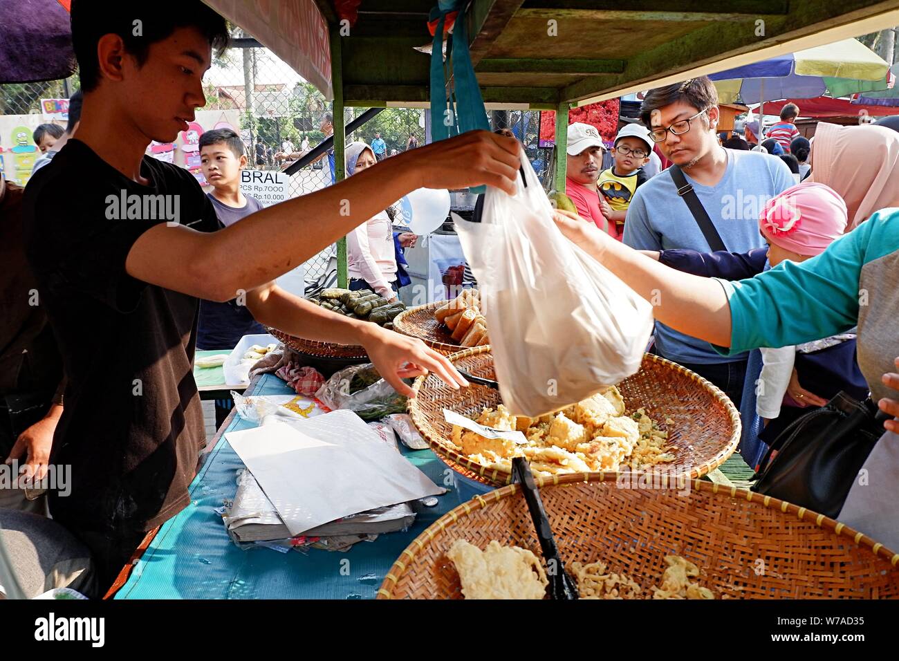 A view of seller and buyer in a street food booth Stock Photo - Alamy