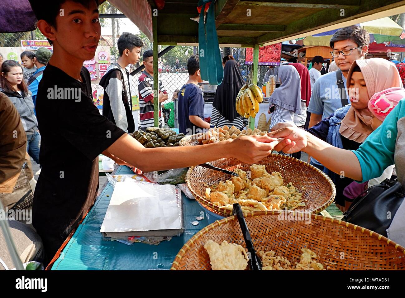 A view of seller and buyer in a street food booth Stock Photo - Alamy