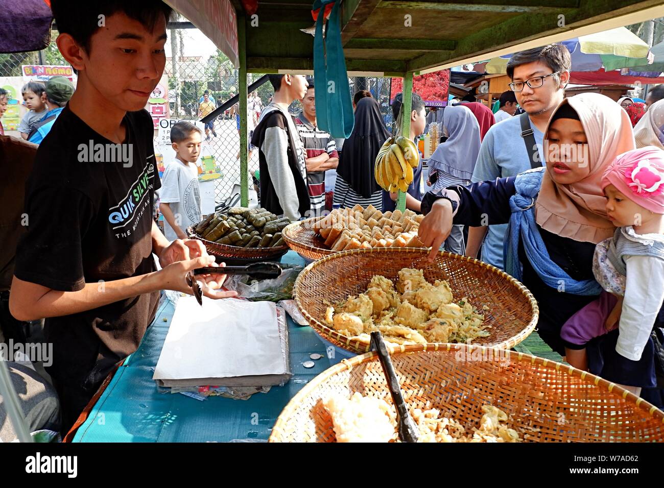 A view of seller and buyer in a street food booth Stock Photo - Alamy