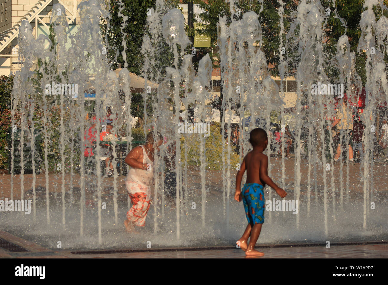 Children enjoying interactive water fountains in summer time Stock ...